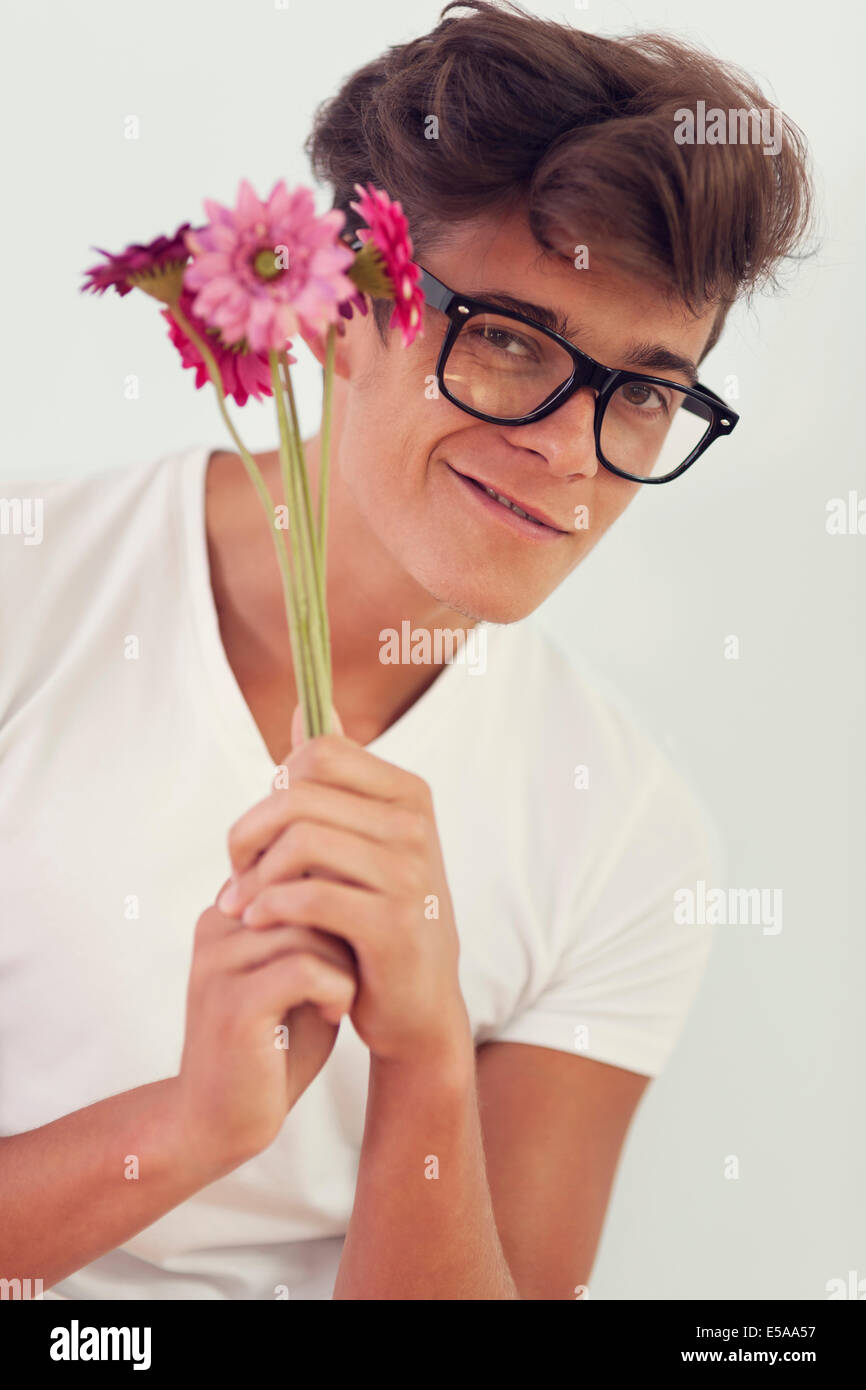 Nerd guy offering pink flower. Debica, Poland Stock Photo - Alamy