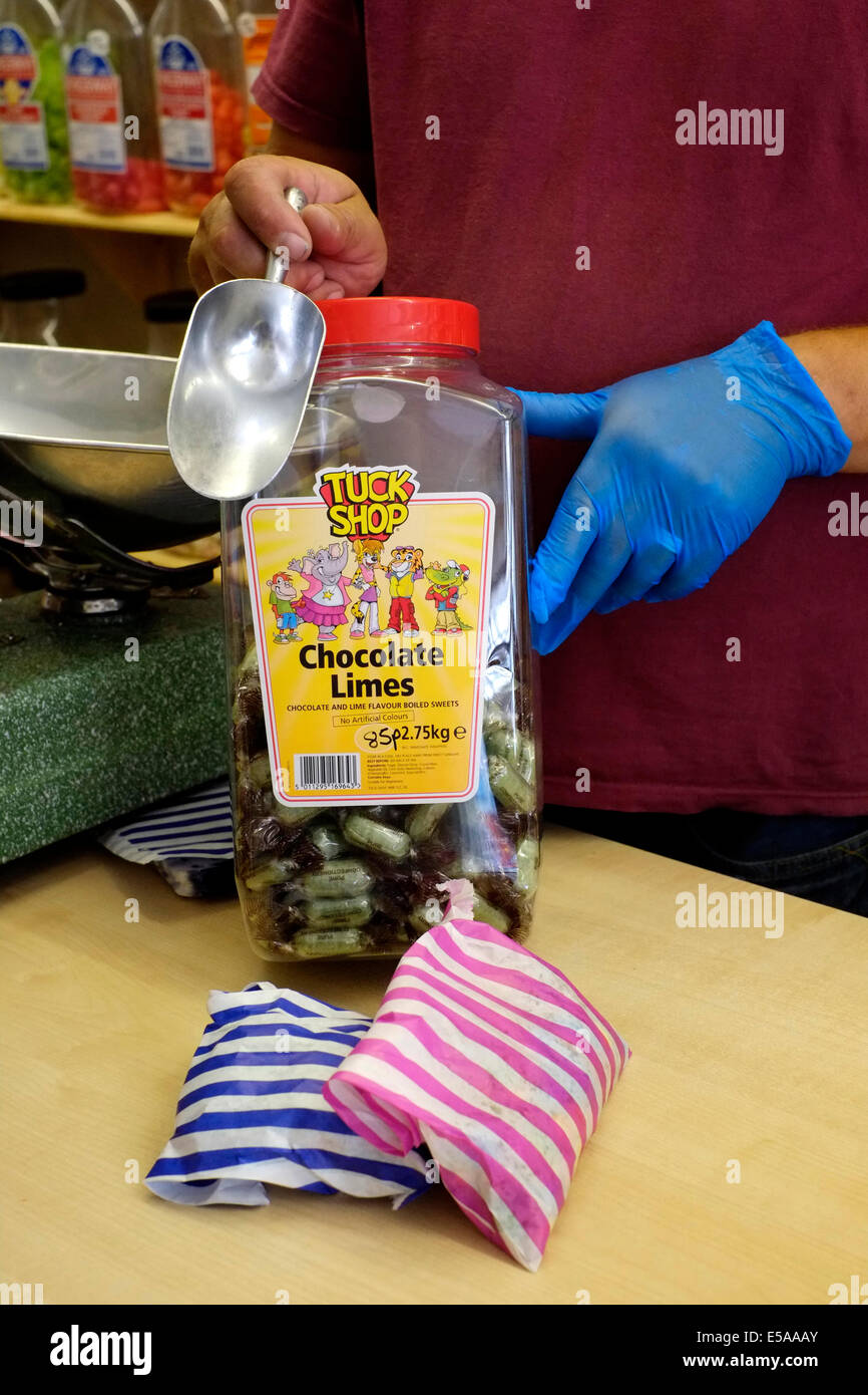 shopkeeper serving sweets at a traditional english sweet shop Stock ...