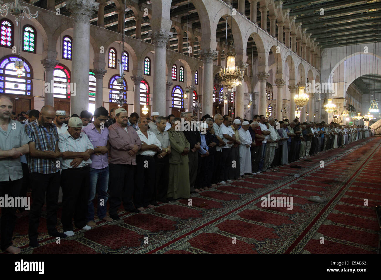 Damascus, Syria. 25th July, 2014. Syrians pray at Umayyad Mosque in the ...