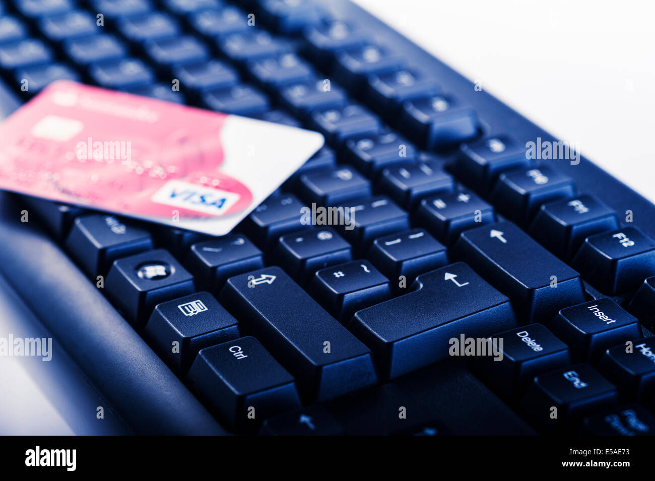 Debit card on a computer keyboard Stock Photo - Alamy