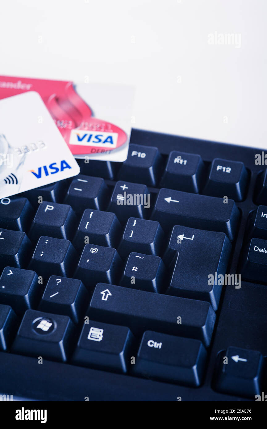 Credit and debit card on a computer keyboard Stock Photo - Alamy