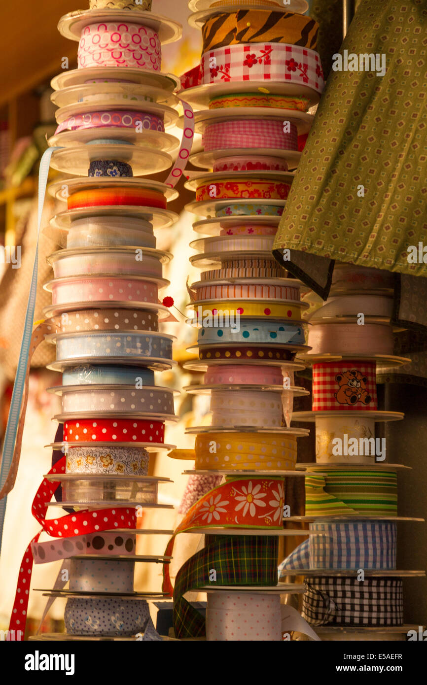 spools of colourful ribbons on a market stall counter in Valencia Spain ...