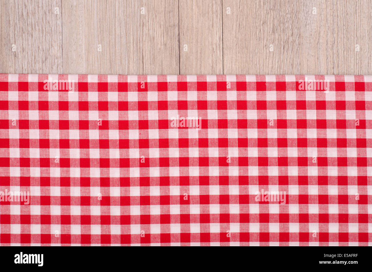 Red and white checkered cloth on wood as background Stock Photo - Alamy