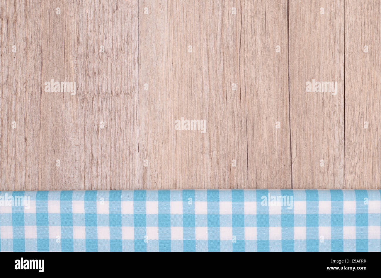 Light blue checkered cloth on wood as background Stock Photo - Alamy