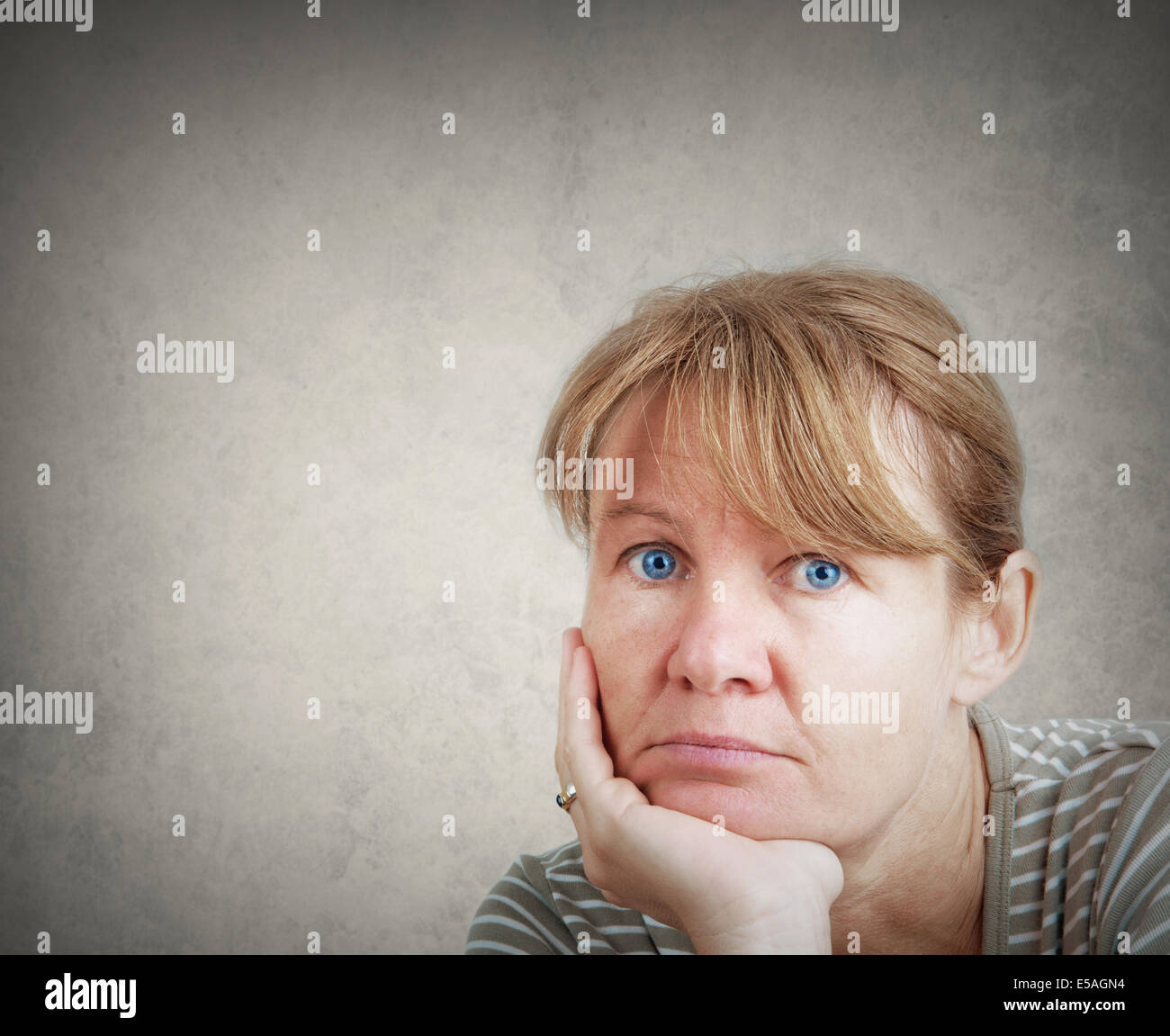 Sad woman looking into the camera Stock Photo - Alamy