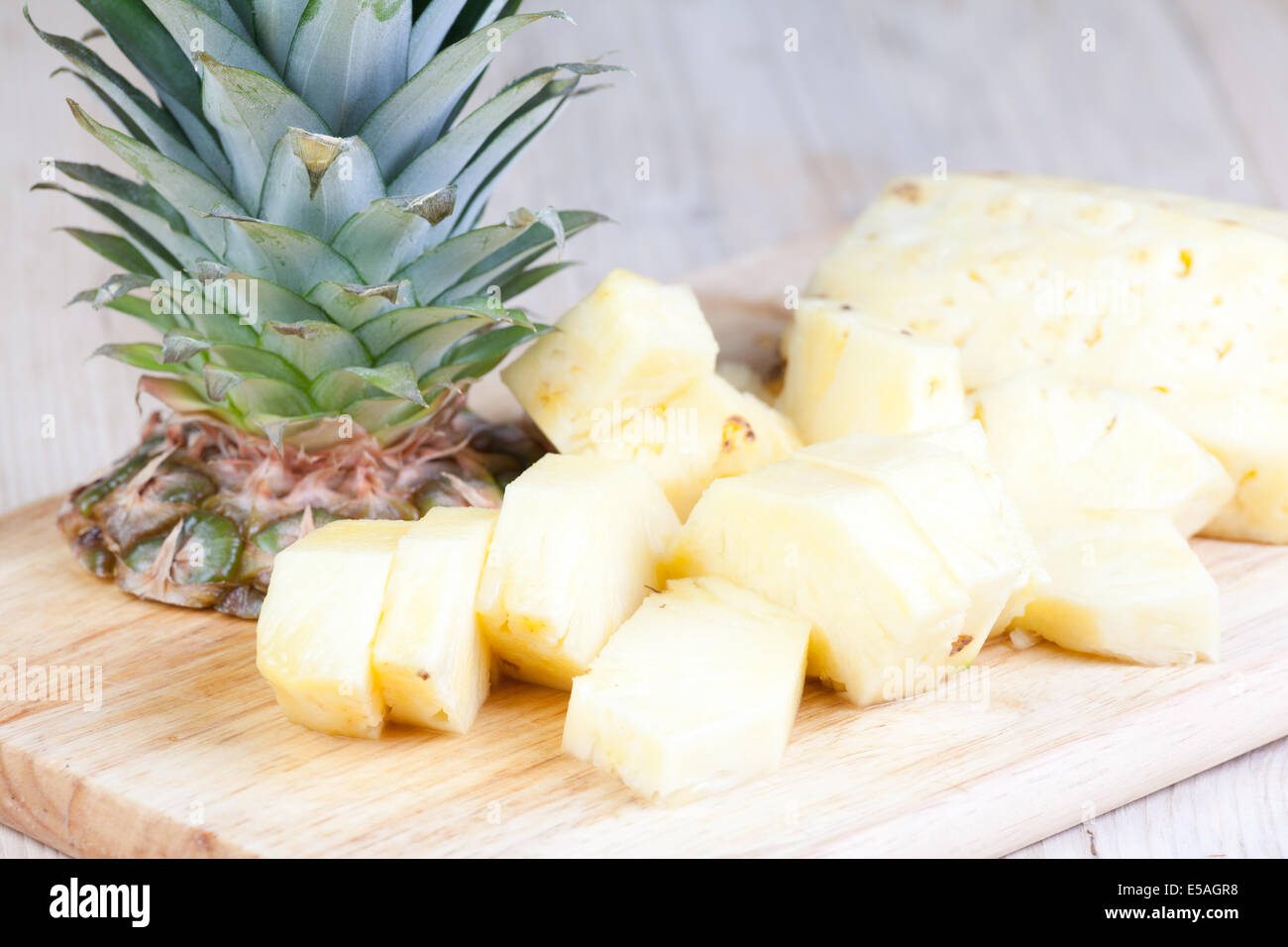 cut pineapple on the wooden board Stock Photo - Alamy