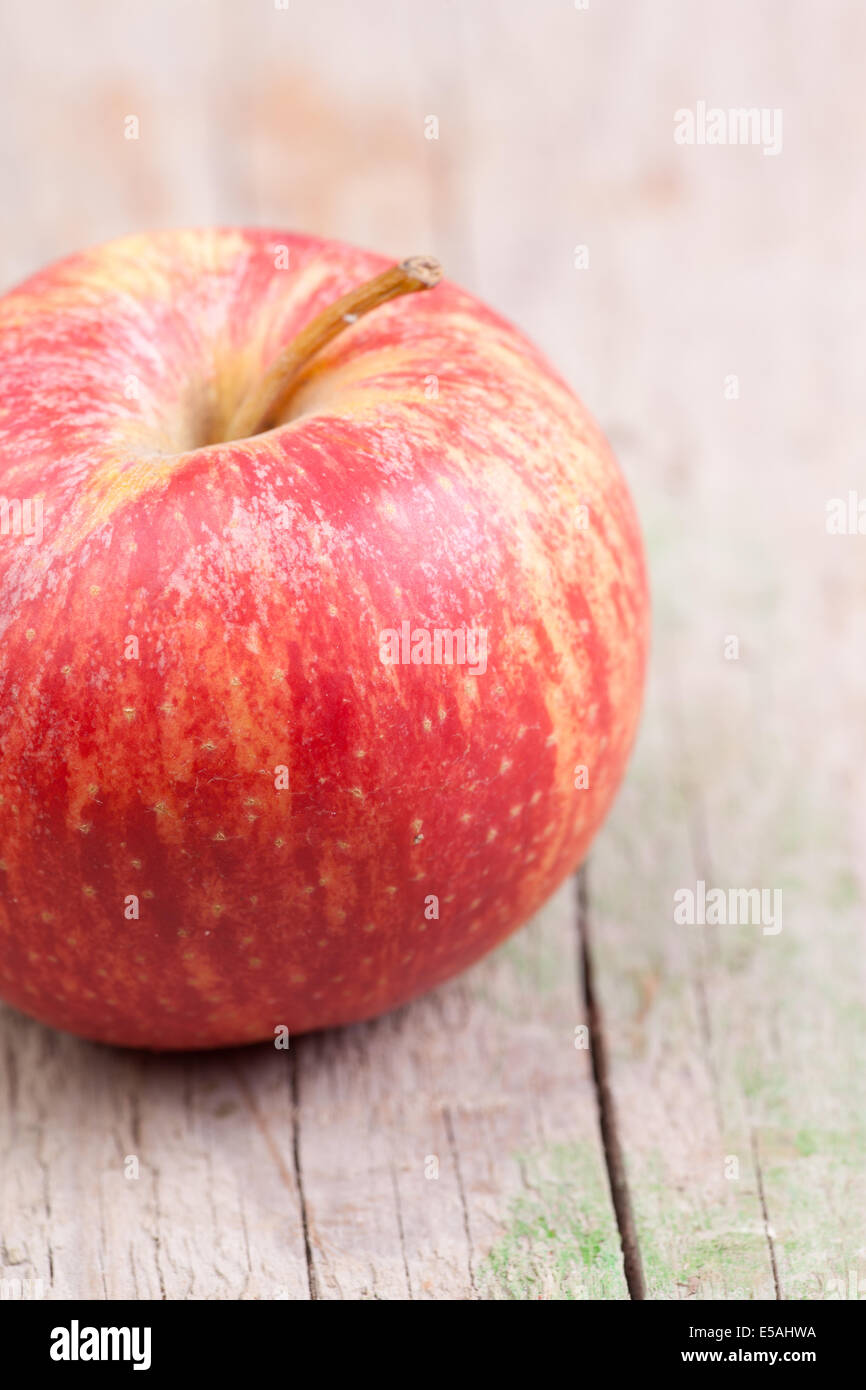 red apple on rough wood vertical picture Stock Photo - Alamy