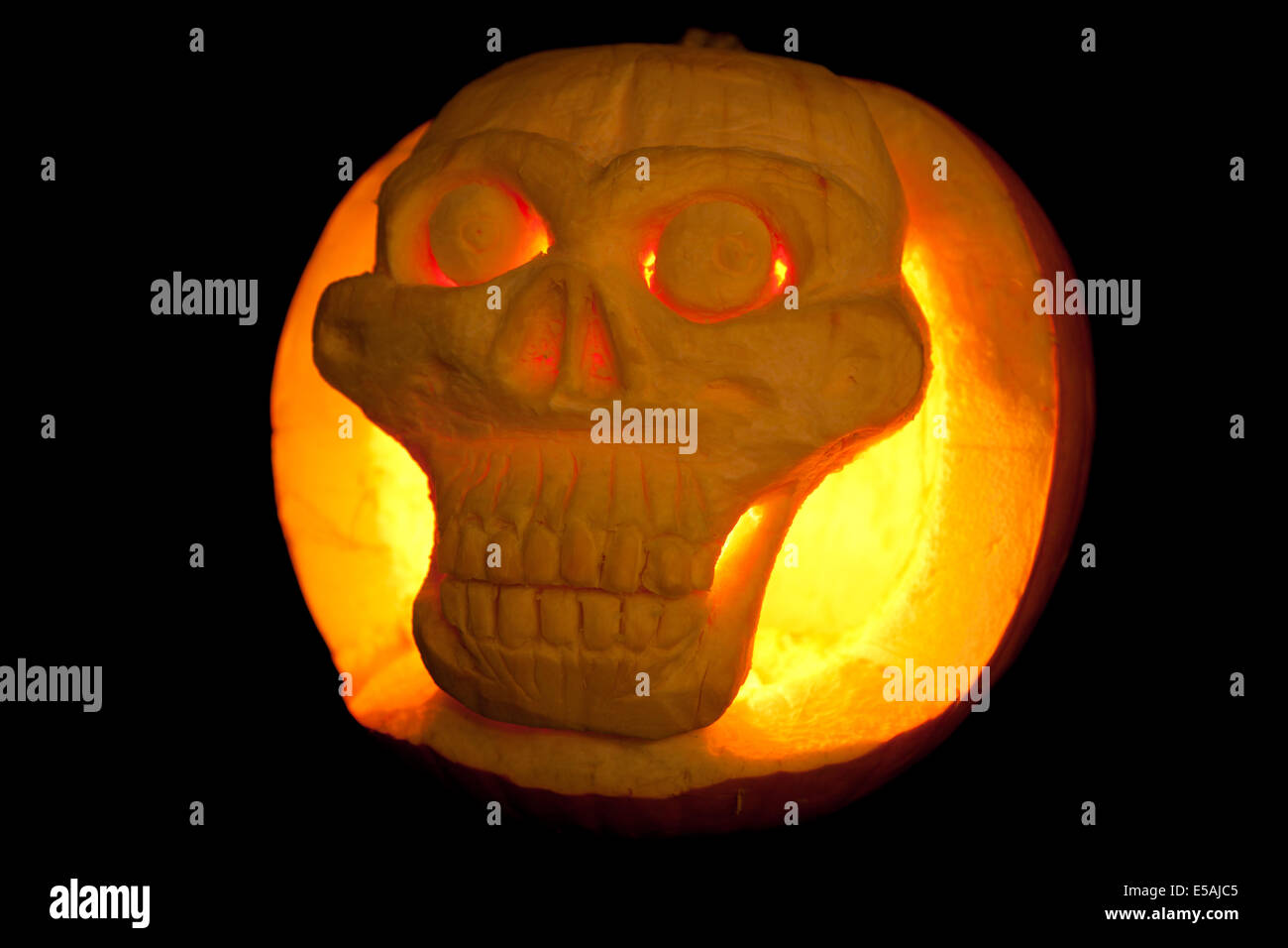 glowing Halloween pumpkin with skull Stock Photo - Alamy