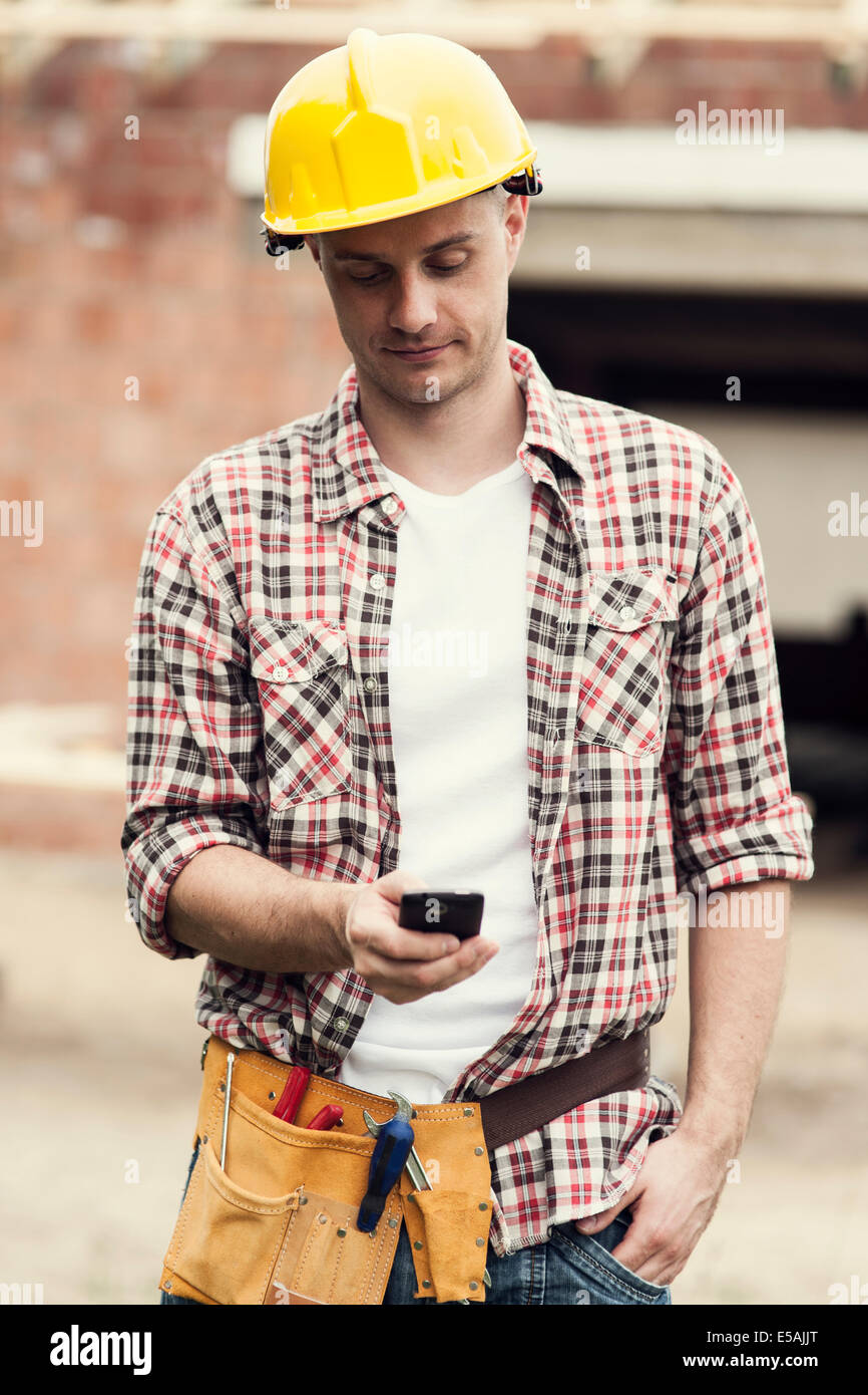 Construction texting on mobile phone hi-res stock photography and ...