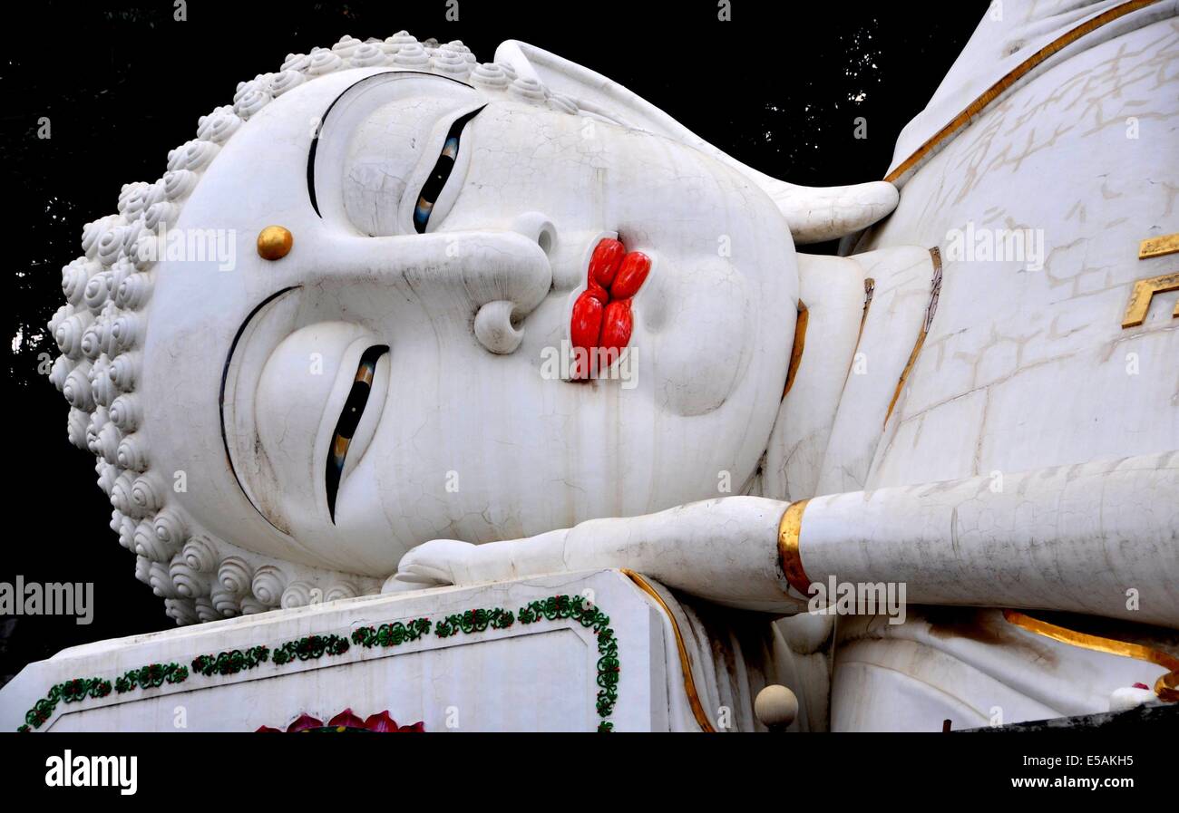 MIANYANG (SICHUAN), CHINA: Face of the immense white alabaster Reclining Buddha at the historic ...