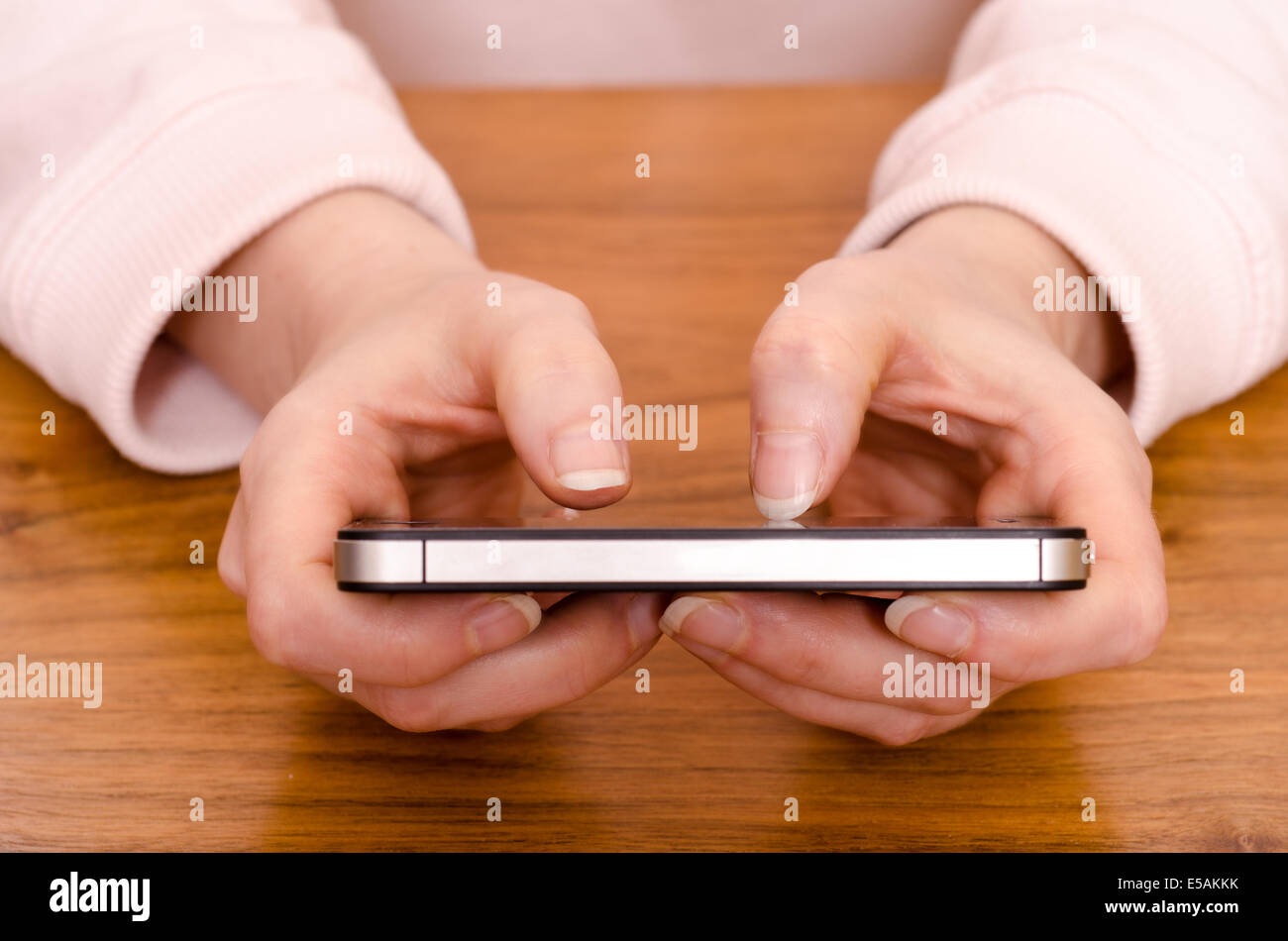 Two female thumbs are typing on a smart phone Stock Photo - Alamy