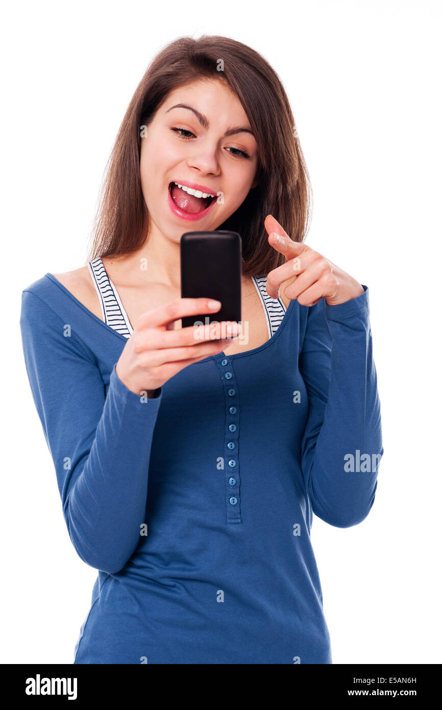 Excitement woman with mobile phone pointing at camera Debica, Poland ...