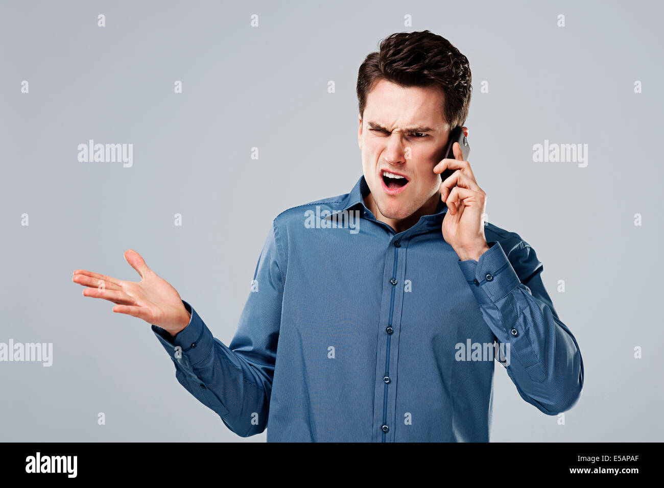 Angry man talking on the phone debica hi-res stock photography and ...