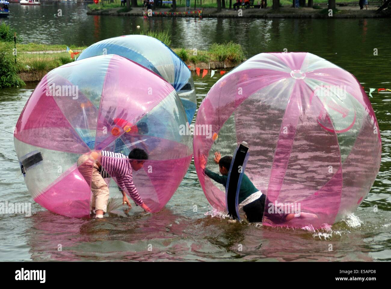PENGZHOU, CHINA: CHILDREN PLAYING IN GIANT PLASTIC INFLATED BALLS ON ...