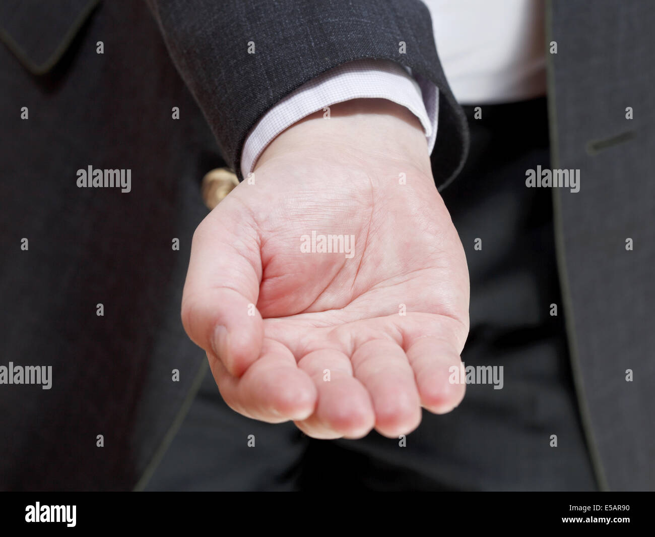 businessman holds empty handful - hand gesture Stock Photo - Alamy