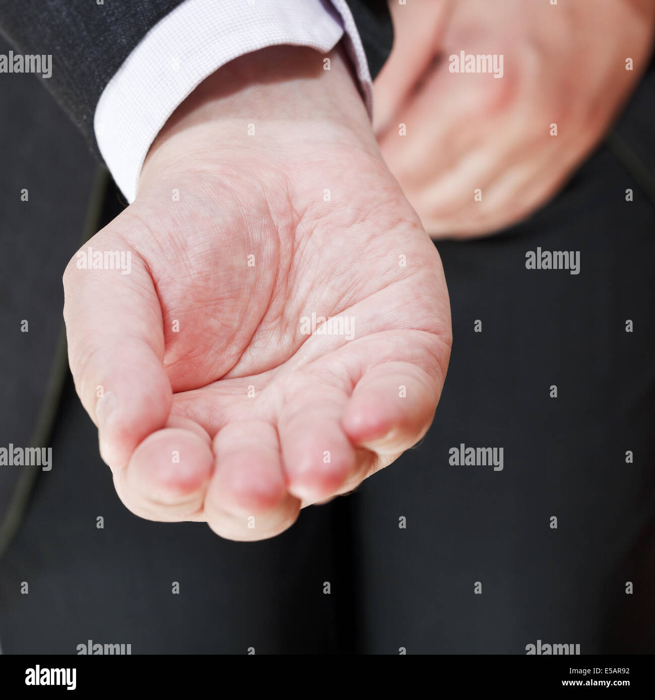 front view of businessman holding empty handful - hand gesture Stock ...