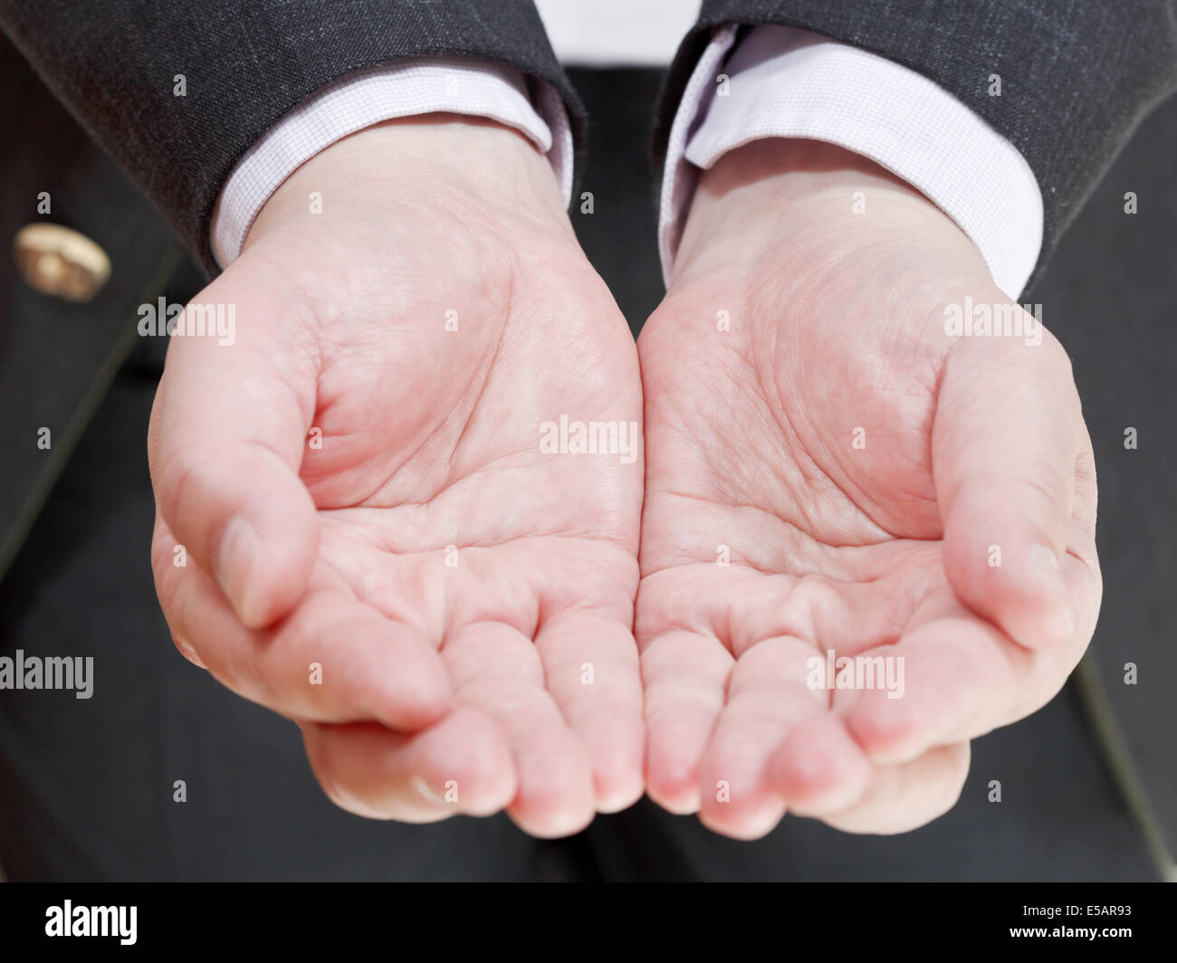 front view of businessman holding empty handful from two palms- hand ...