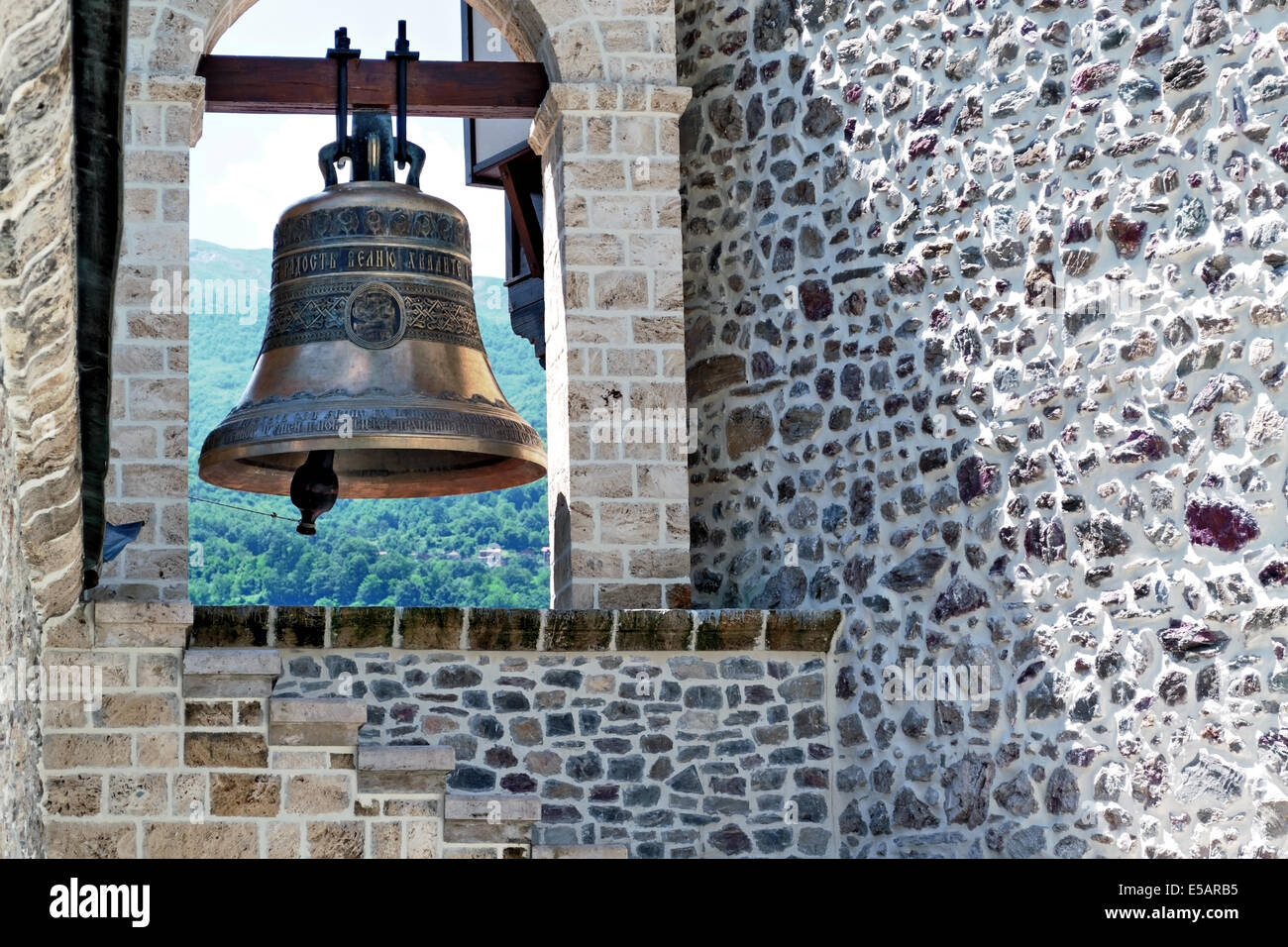 Church bell and rustic stone wall Stock Photo - Alamy