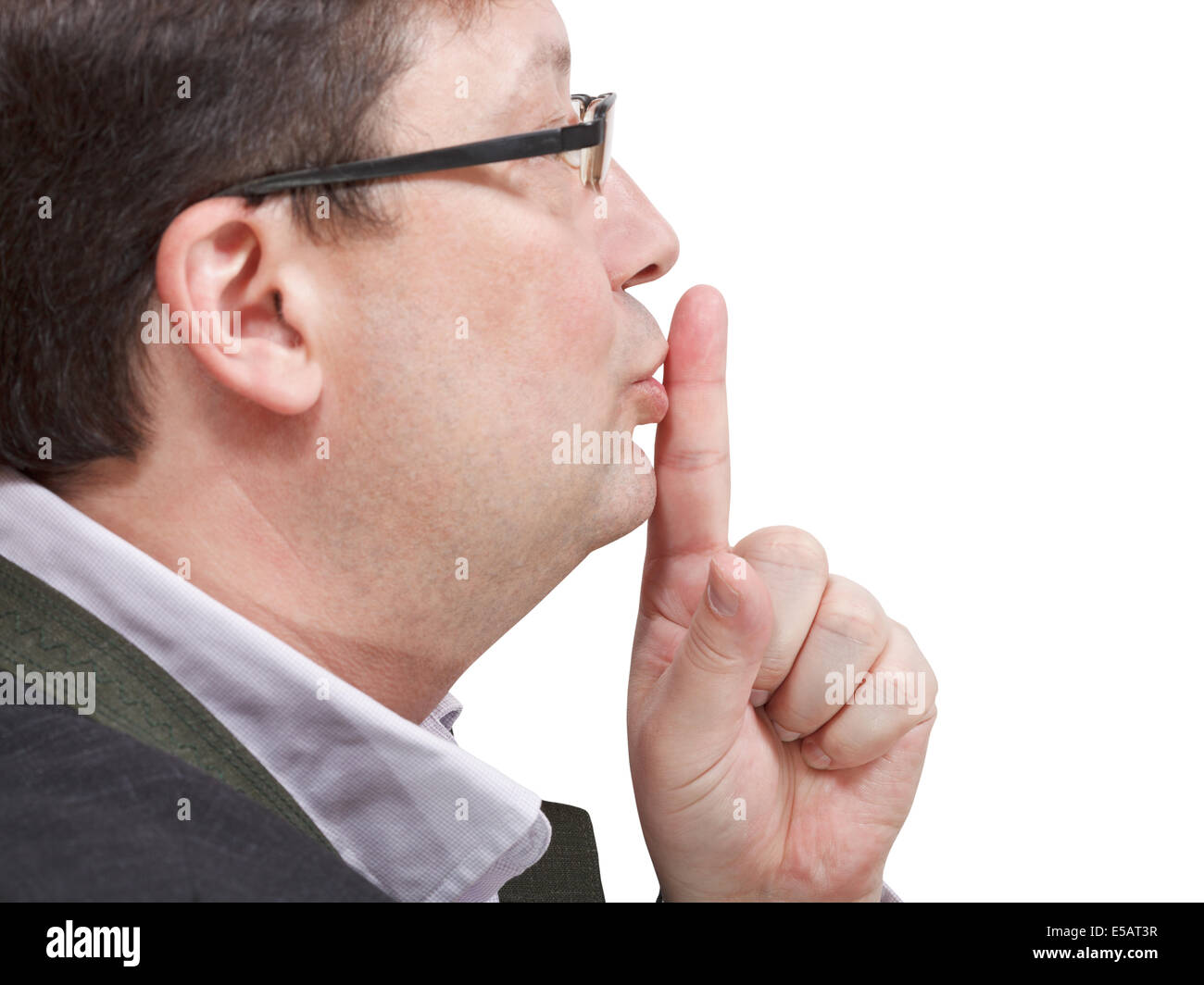 side view of businessman's finger near lips - silence hand gesture ...