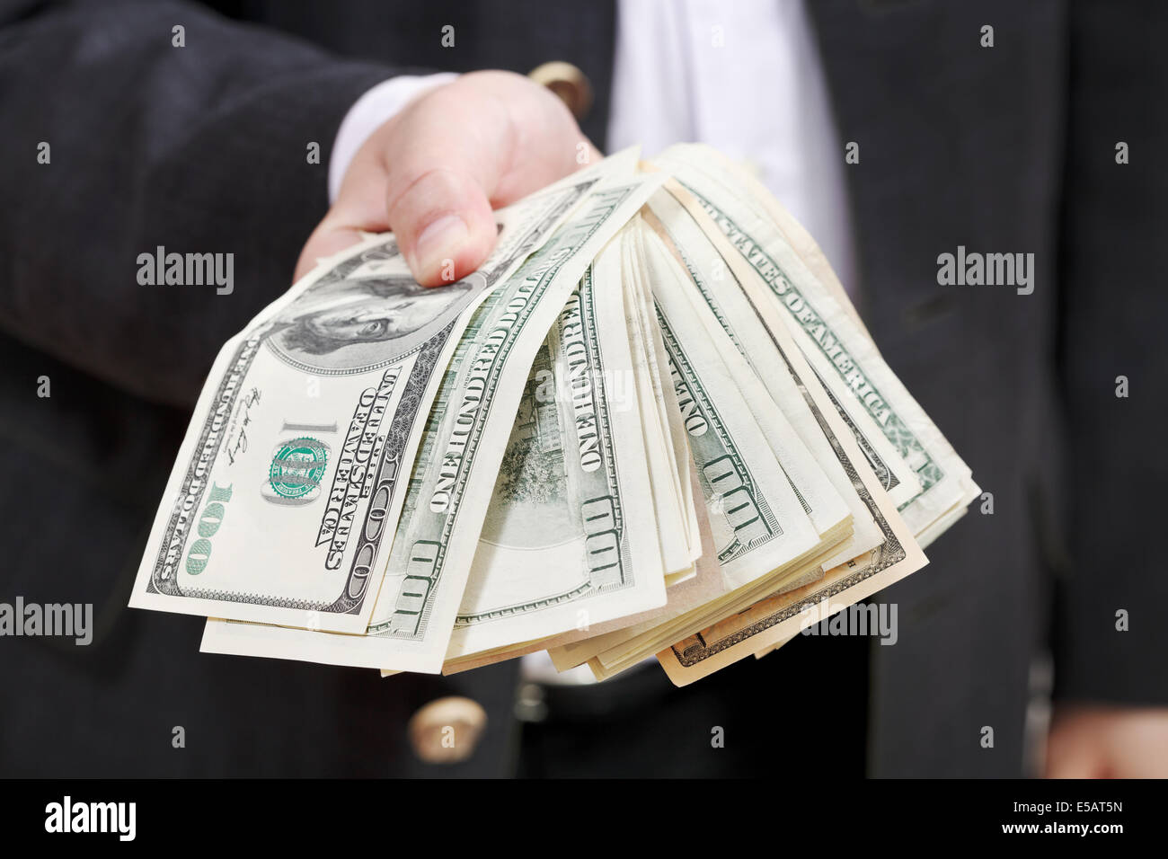 front view of fanned dollar banknotes in male hands isolated on white ...
