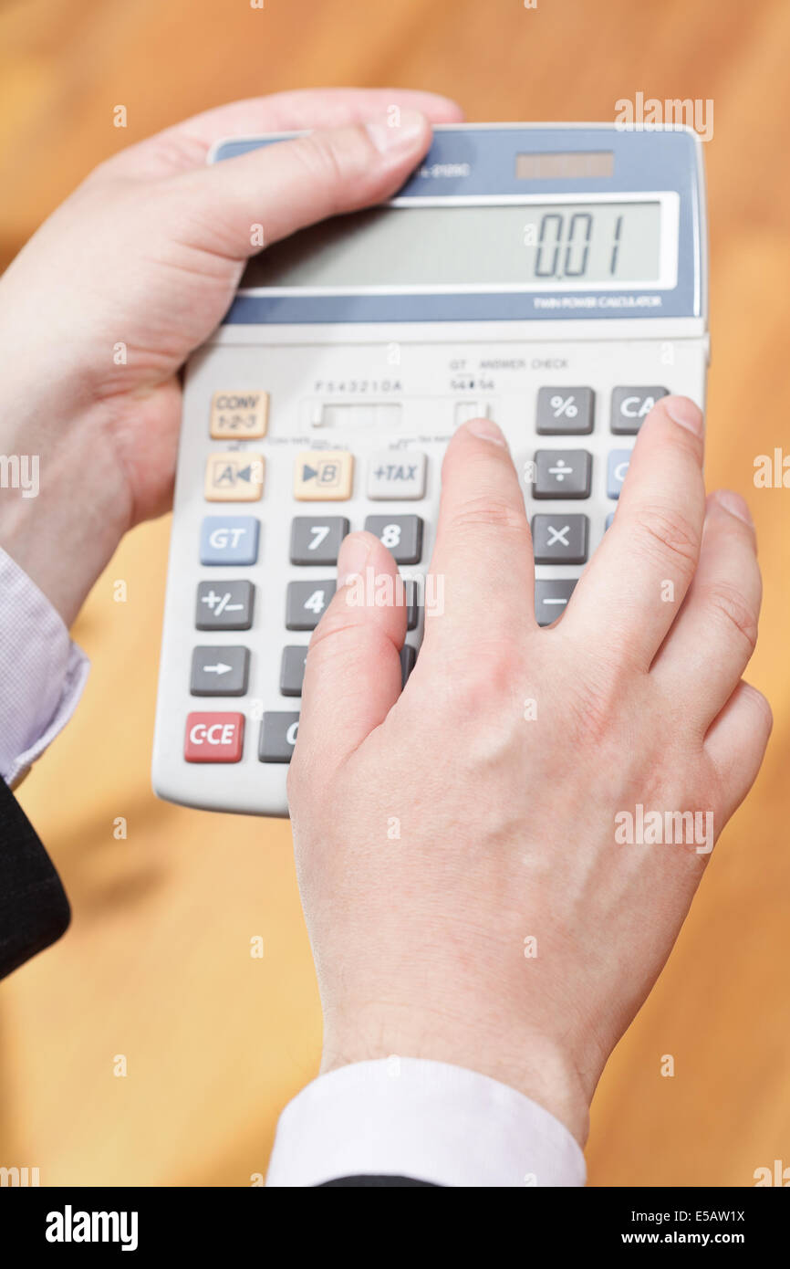 above view of calculator in male hands close up Stock Photo - Alamy