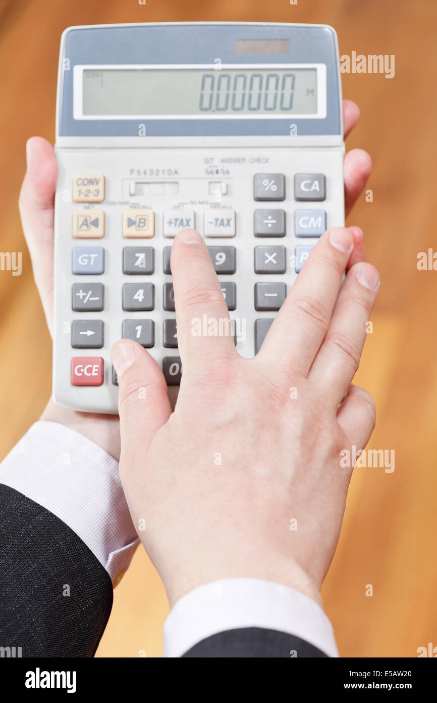 above view of calculator in accountant hands close up Stock Photo - Alamy