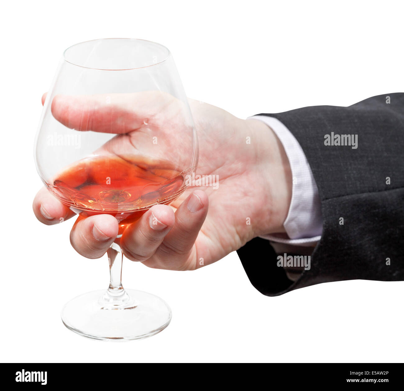 side view of brandy glass in male hand isolated on white background ...
