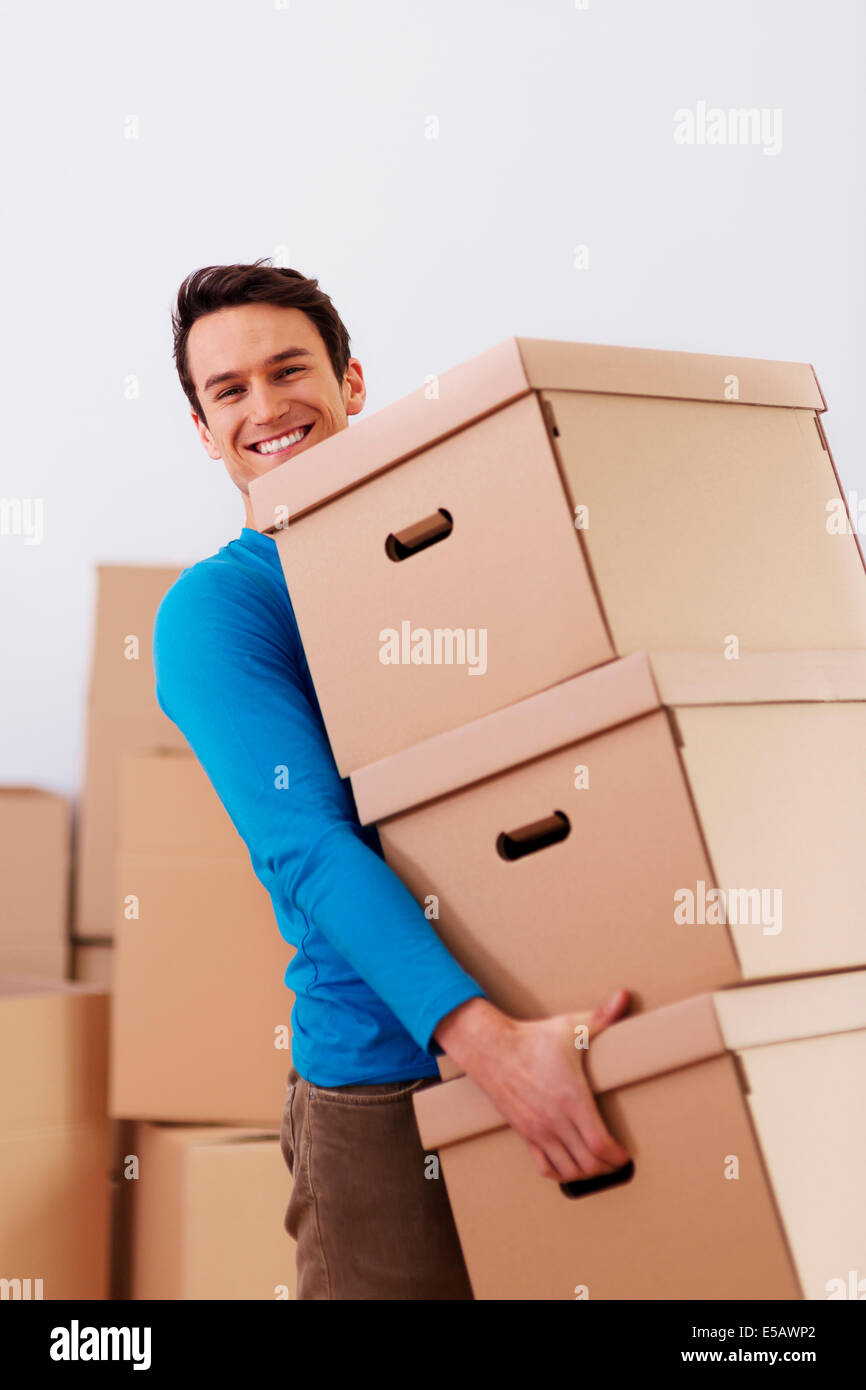 Handsome man carrying stack of boxes Debica, Poland Stock Photo - Alamy
