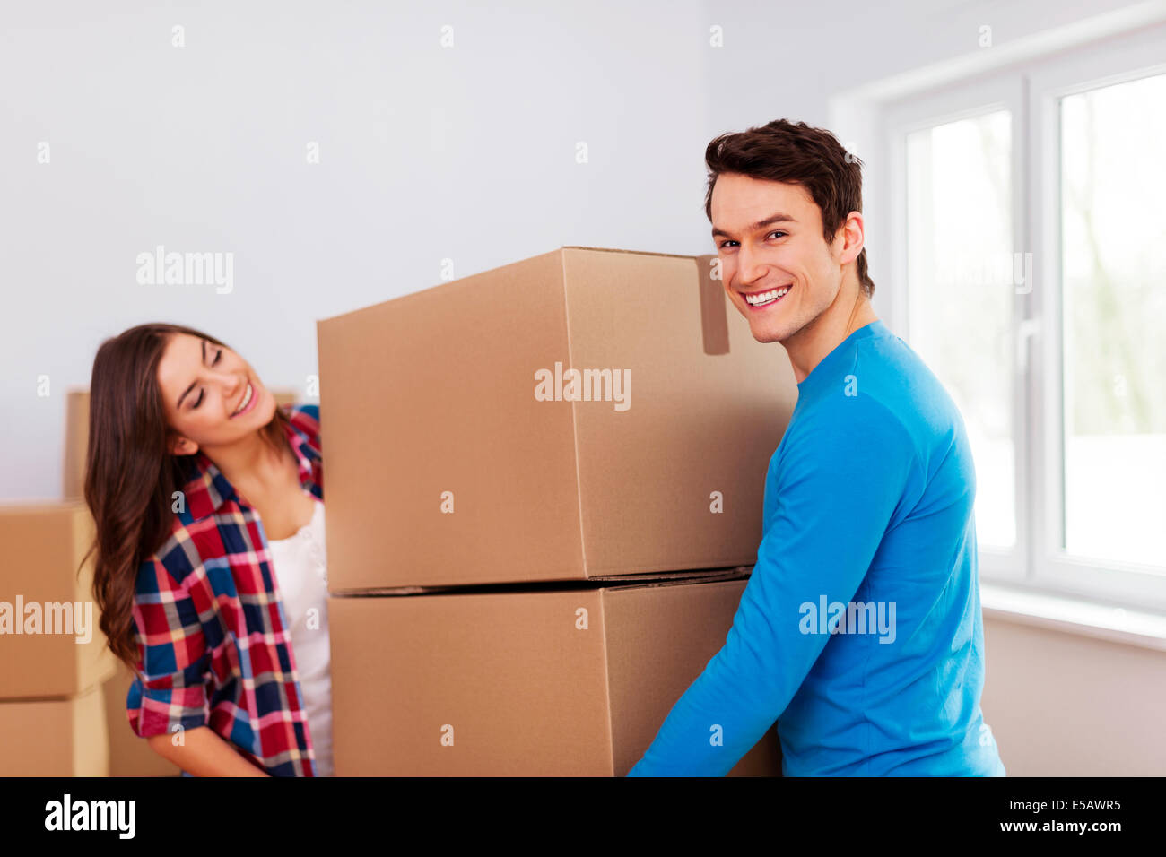 Young couple carrying boxes debica hi-res stock photography and images ...