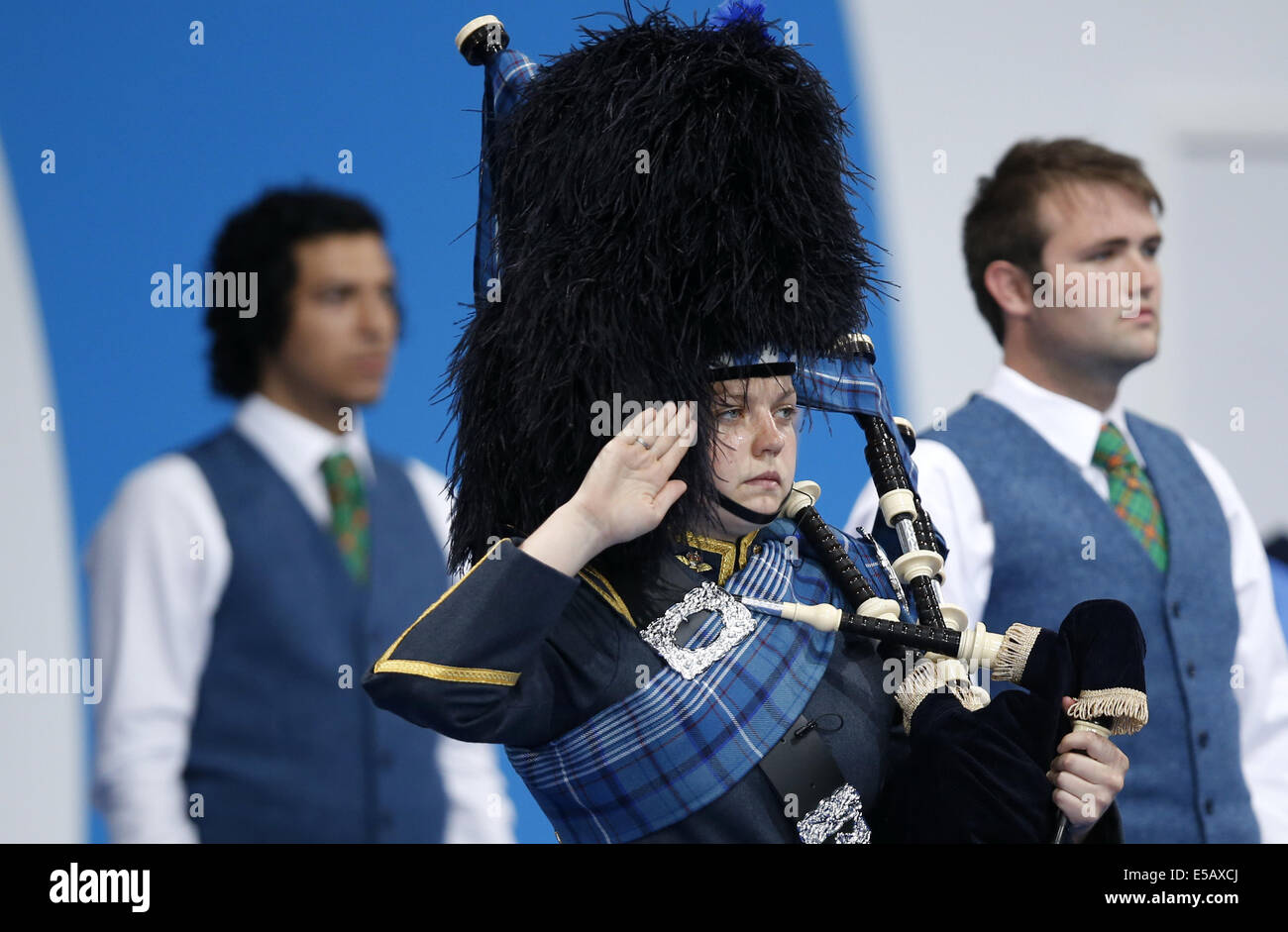 Glasgow. 25th July, 2014. The Scottish bagpipe player reacts during the ...