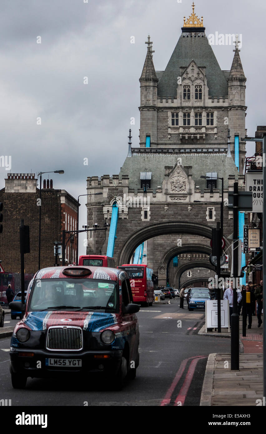 London cab driving away from London Bridge at Borough High St. in a ...