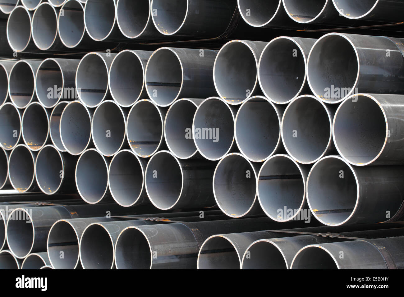 stack of steel pipes industrial background Stock Photo - Alamy