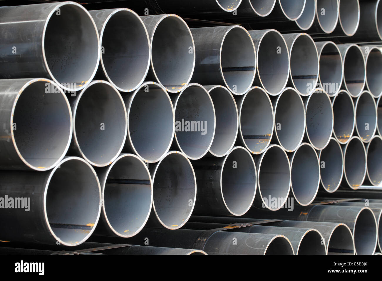stack of steel pipes industrial background Stock Photo - Alamy
