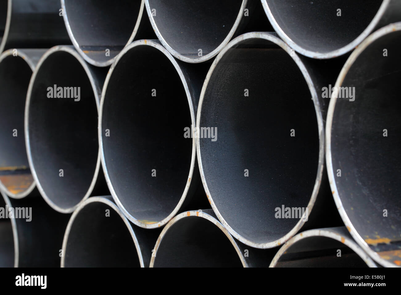 stack of steel pipes industrial background Stock Photo - Alamy