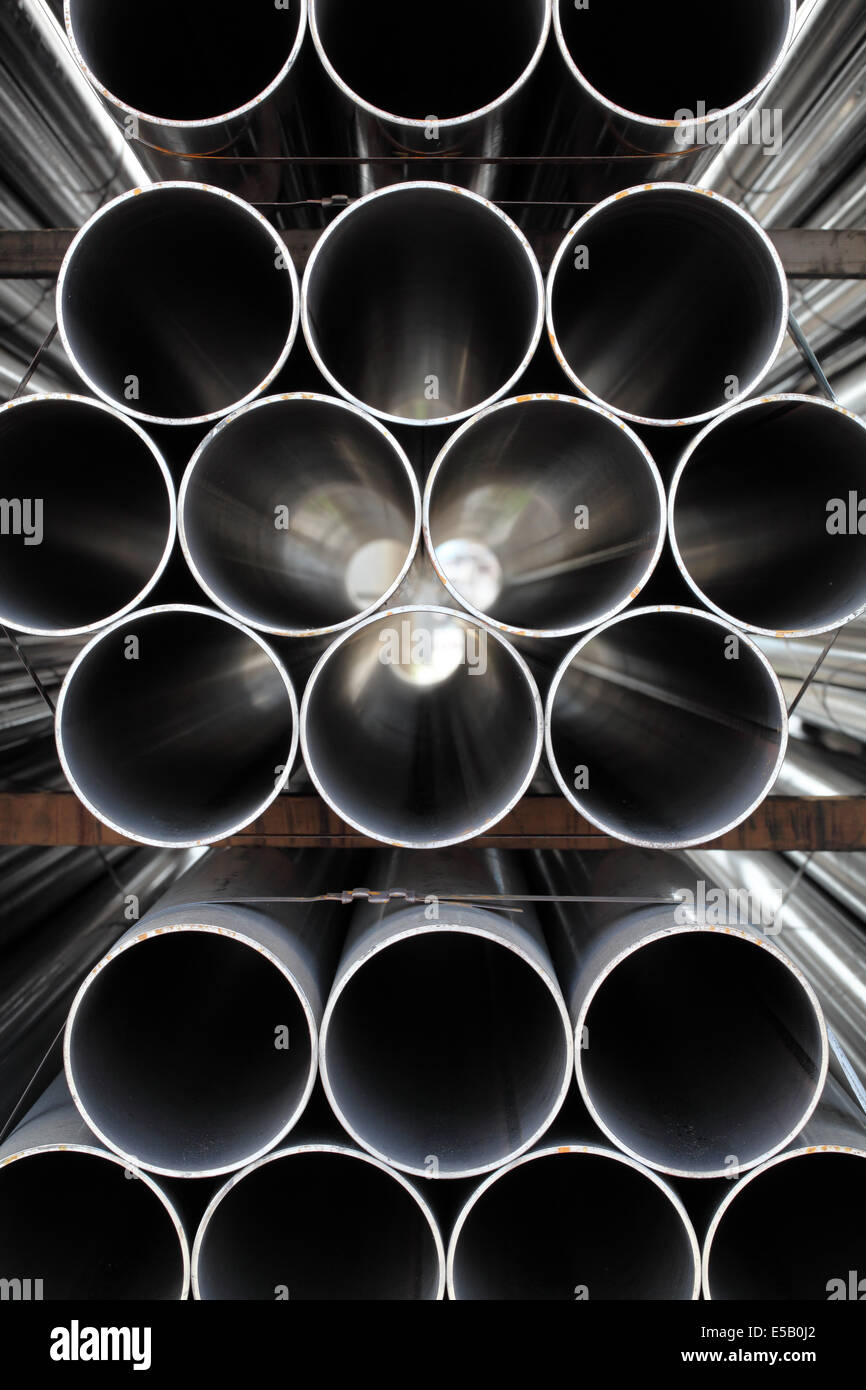 stack of steel pipes industrial background Stock Photo - Alamy