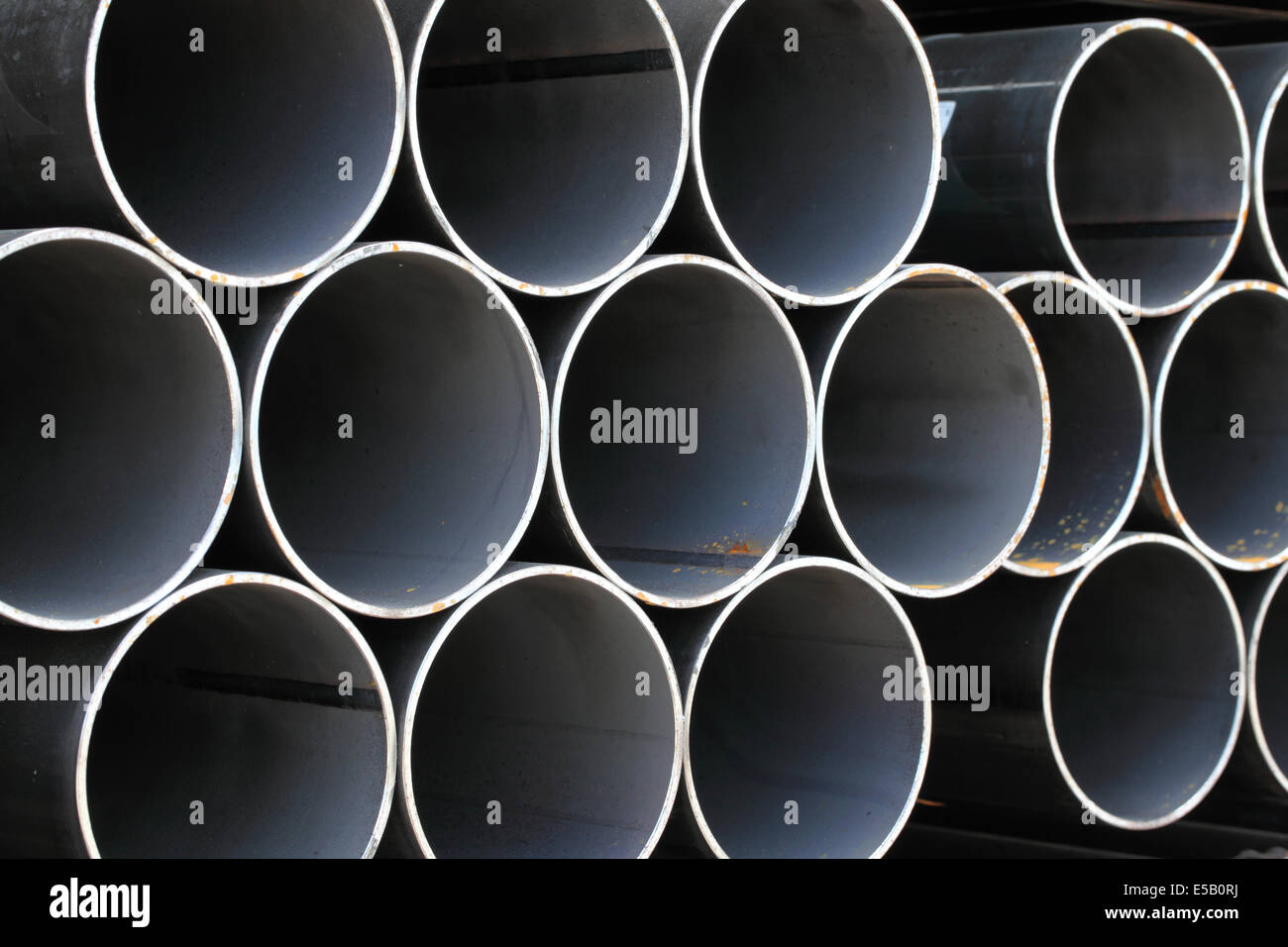 stack of steel pipes industrial background Stock Photo - Alamy