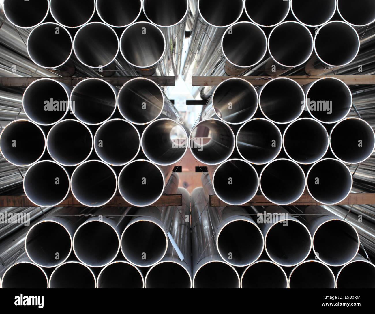 stack of steel pipes industrial background Stock Photo - Alamy