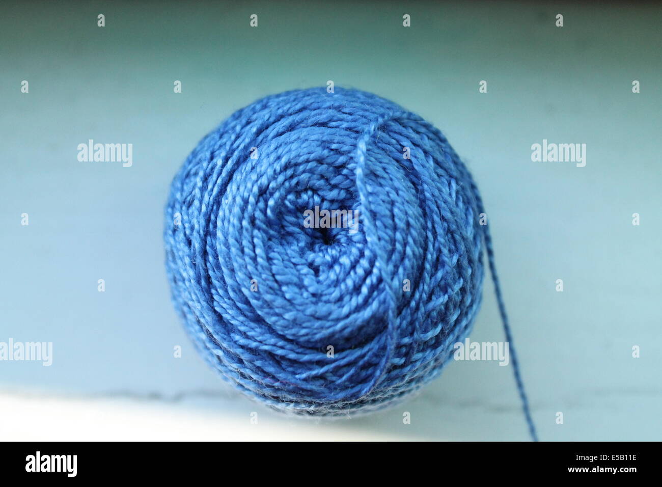 blue shine threads of yarn twisted in little ball Stock Photo - Alamy