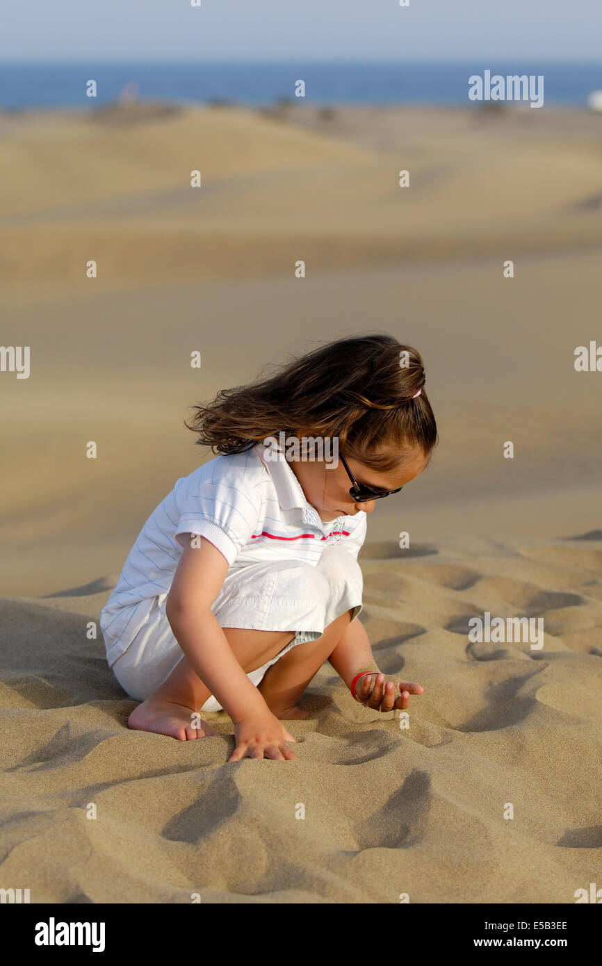 Young child is playing with sand Stock Photo - Alamy