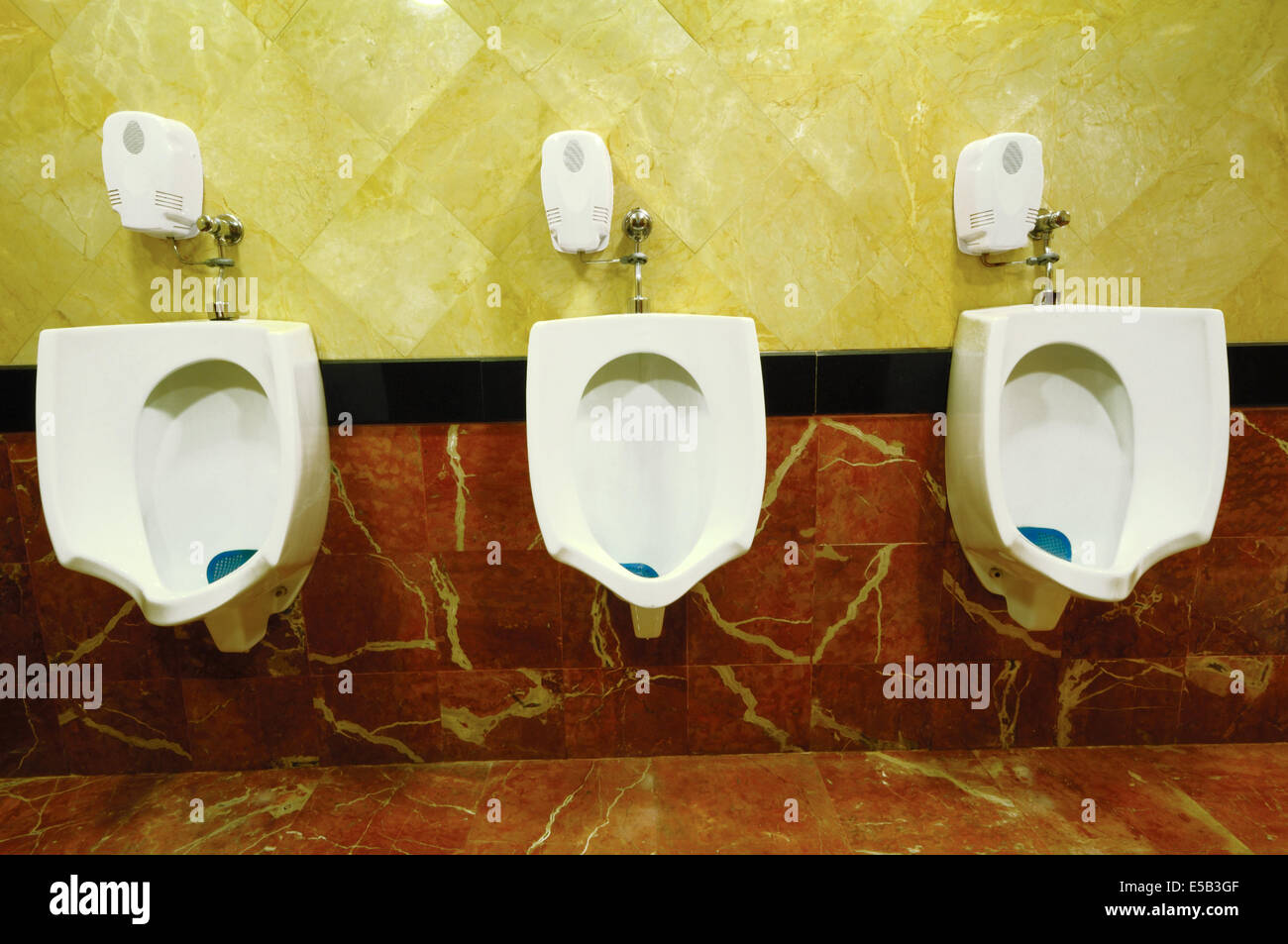 Three Urinals in a row Stock Photo - Alamy