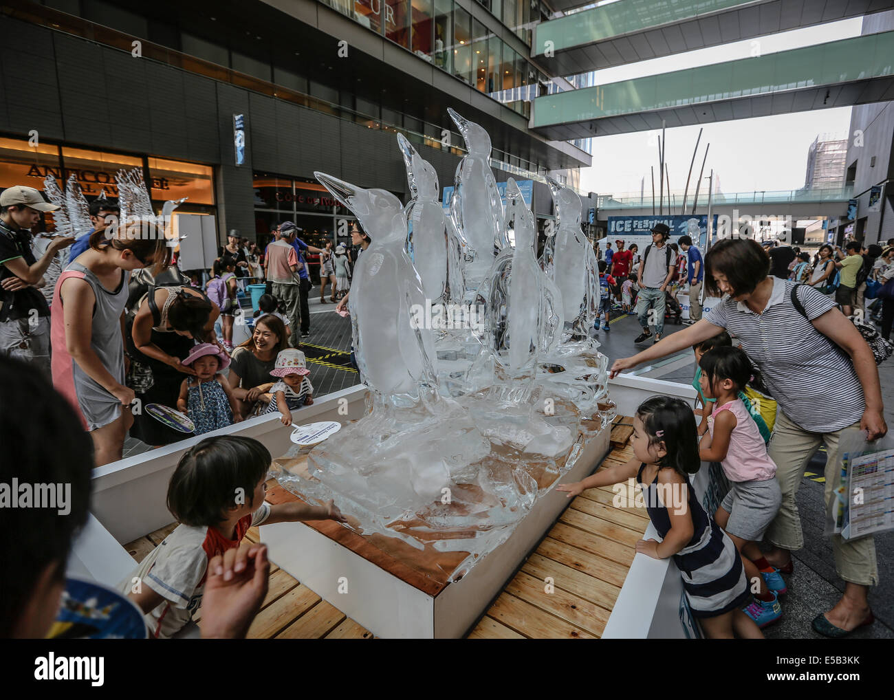 Tokyo, Japan. 26th July, 2014. Visitors touch a ice sculpture of ...