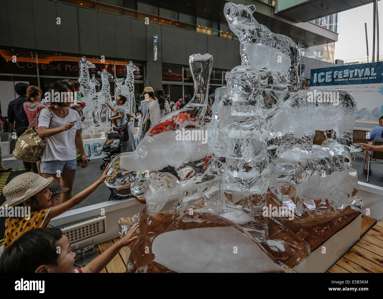 Tokyo, Japan. 26th July, 2014. Visitors touch a ice sculpture of seals ...