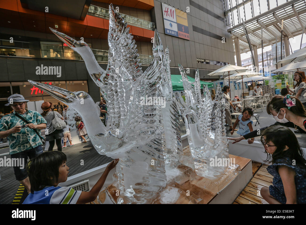 Tokyo, Japan. 26th July, 2014. Visitors touch a ice sculpture of red ...