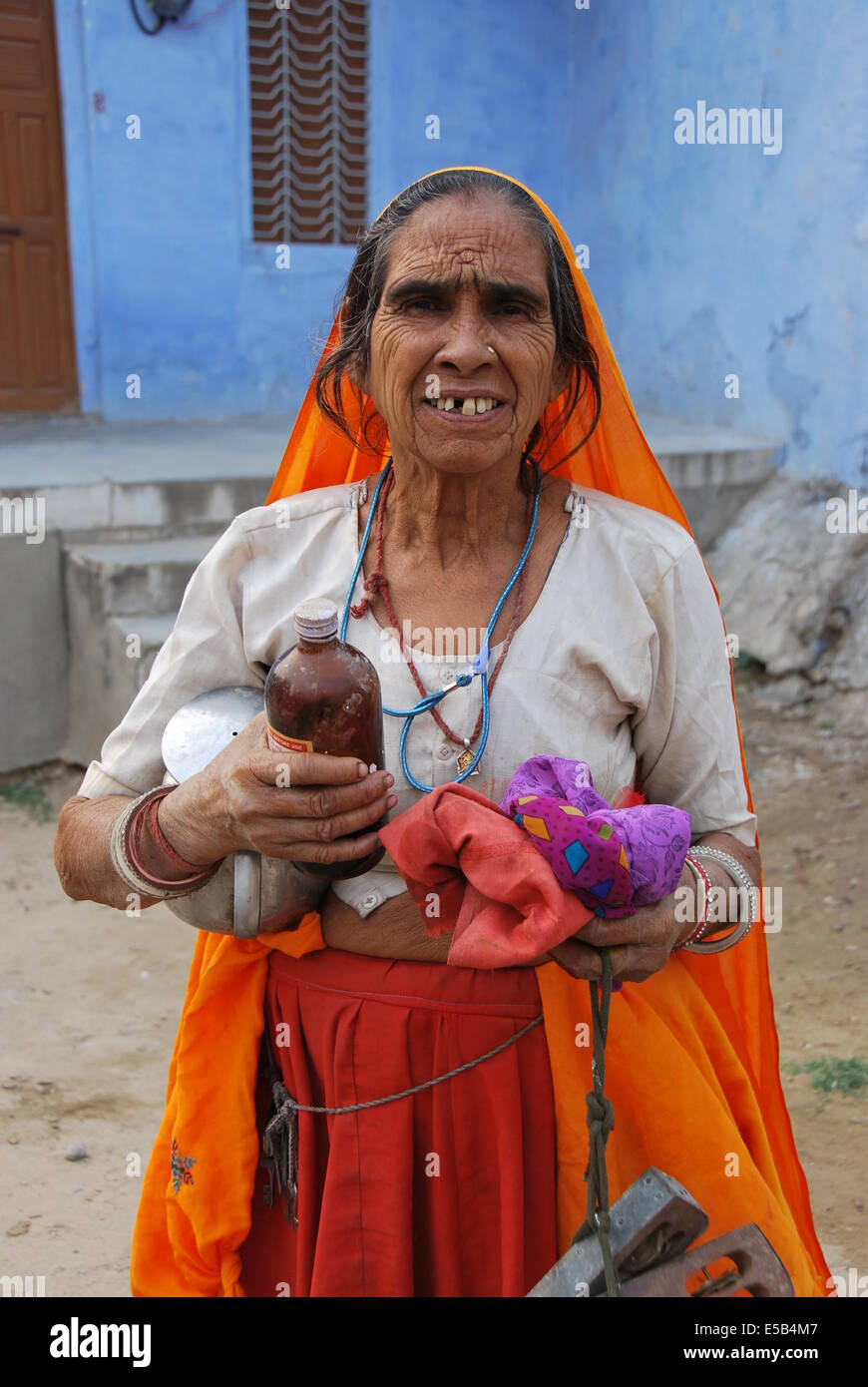 India. Rajasthan. Village woman.Dressed in orange . medicine bottle ...