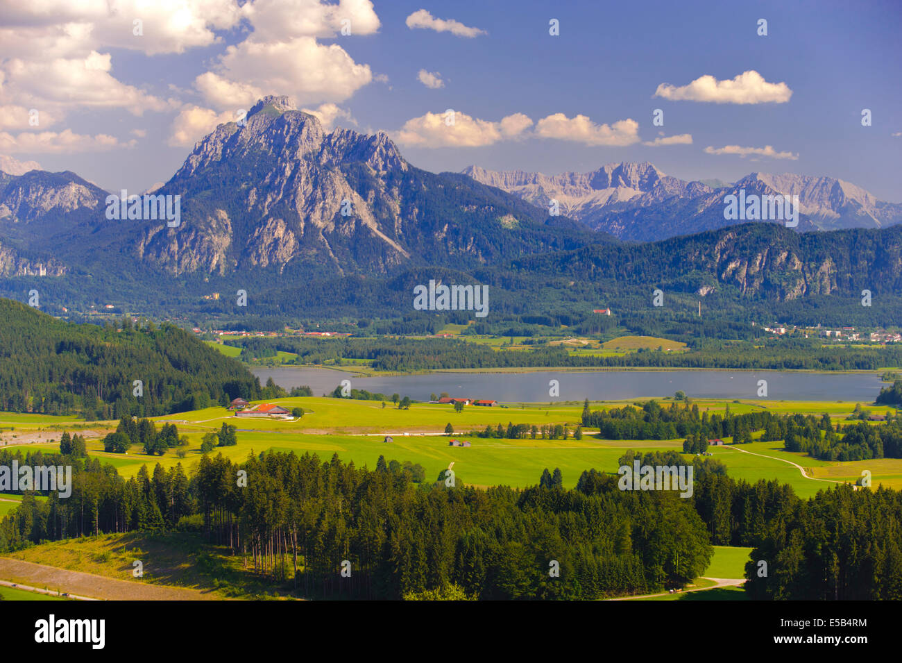wide panorama landscape in Bavaria with lake Hopfensee and alps ...