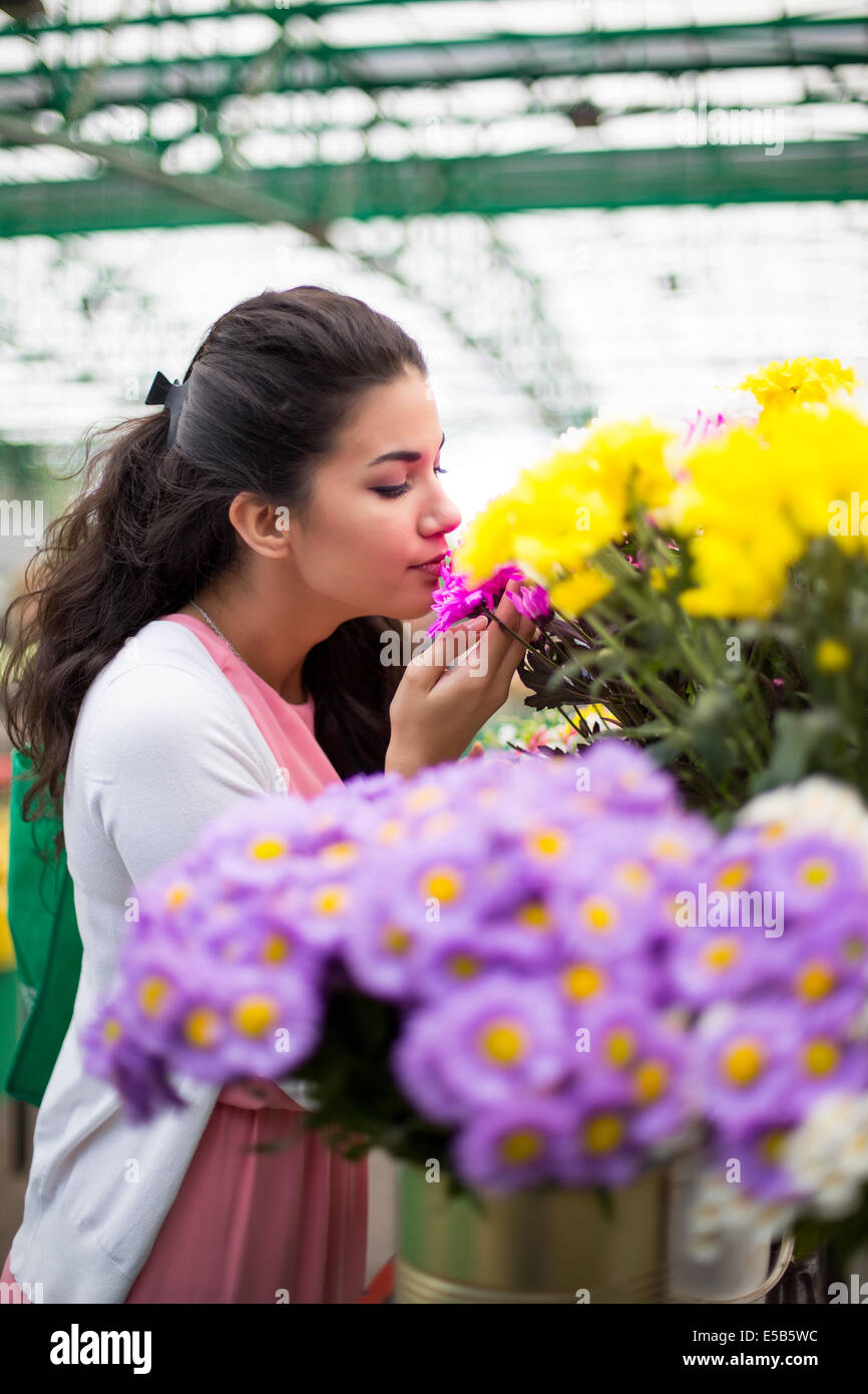 Young woman buying flowers at market Stock Photo - Alamy