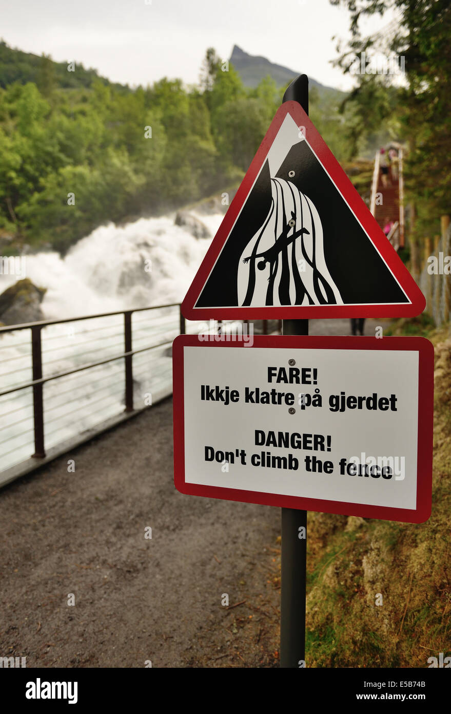 Warning sign beside waterfall Stock Photo - Alamy