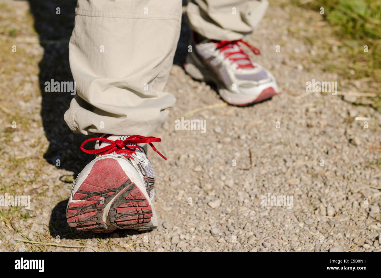 Two feet with shoes and red shoelaces are hiking Stock Photo - Alamy