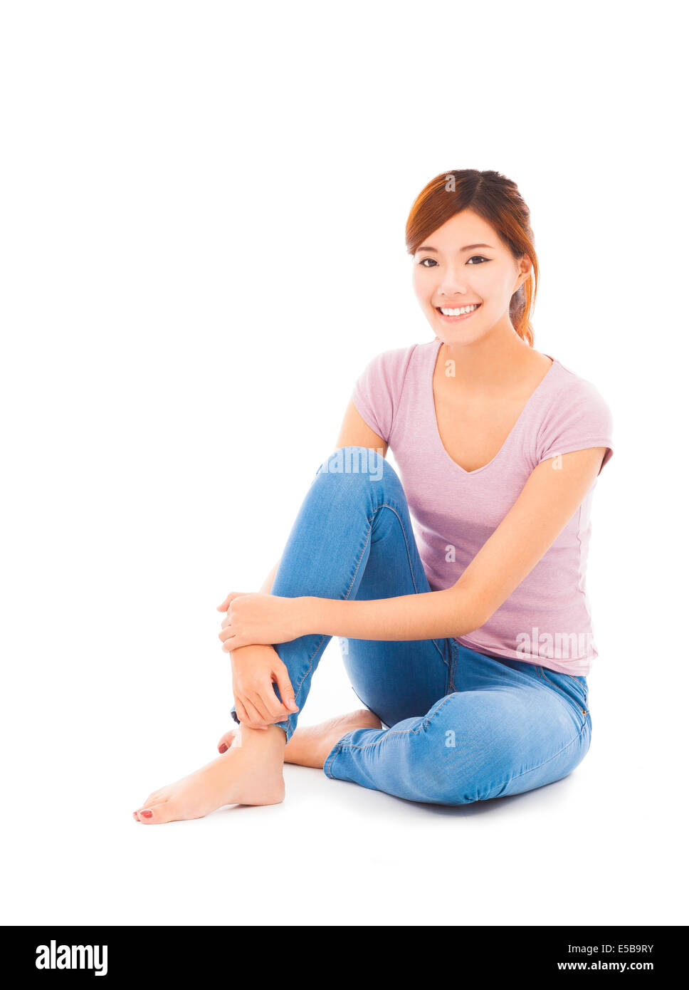smiling beautiful young woman sitting on the floor Stock Photo - Alamy