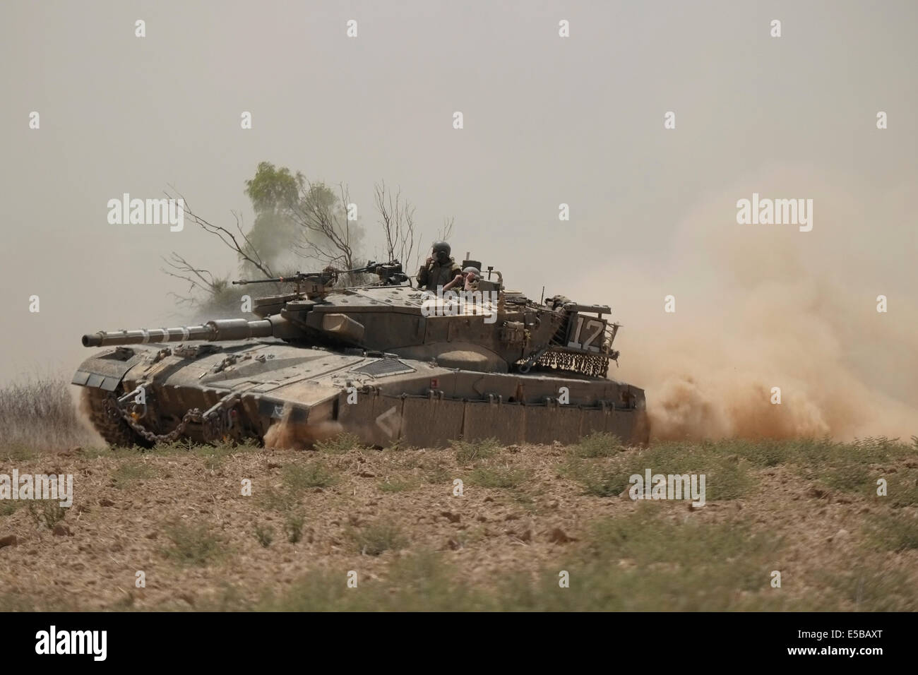 A Merkava tank of the Israeli army maneuvering near the border with ...